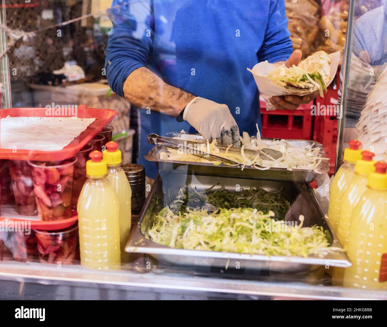 Chef making traditional turkish street food Balik Ekmek mixing roasted ...