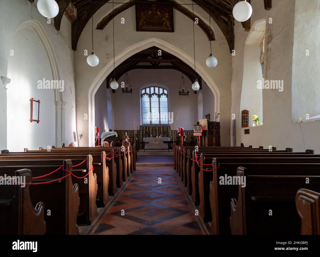 Wooden pews chancel arch view to altar and east window, Denham church ...