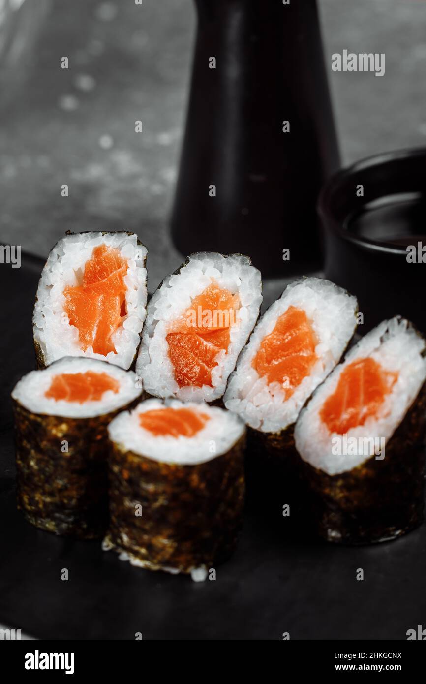 Simple maki with fresh salmon. Sushi on a gray background Stock Photo ...