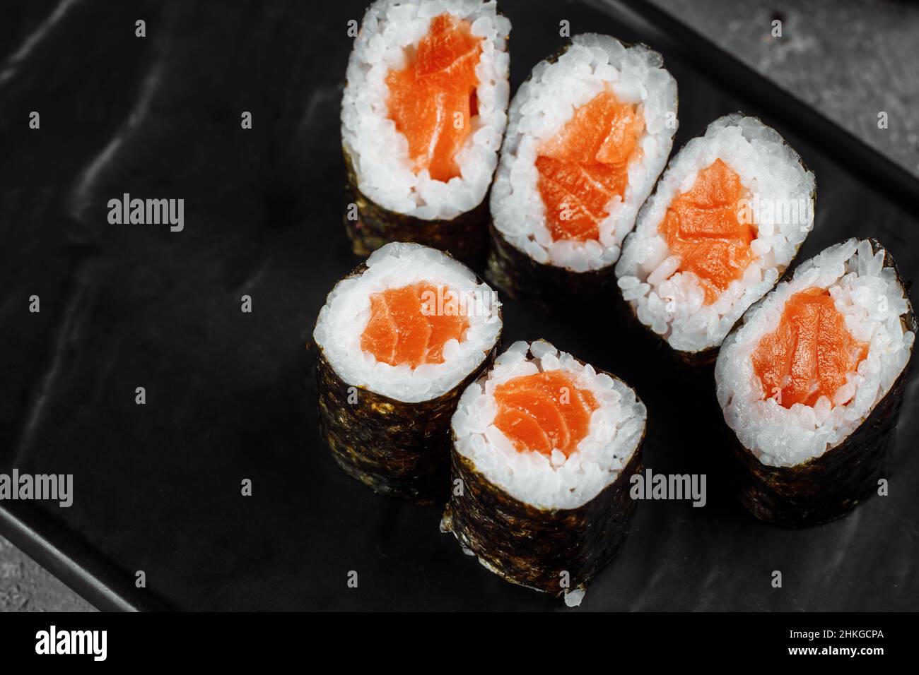 Simple maki with fresh salmon. Sushi on a gray background Stock Photo ...