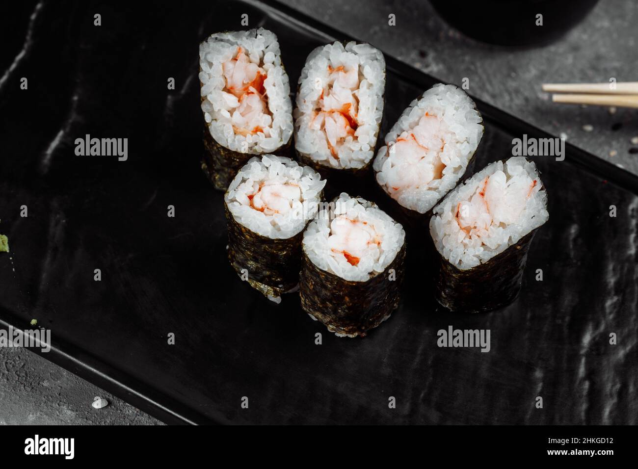 Simple maki with shrimp. Sushi on a gray background Stock Photo - Alamy