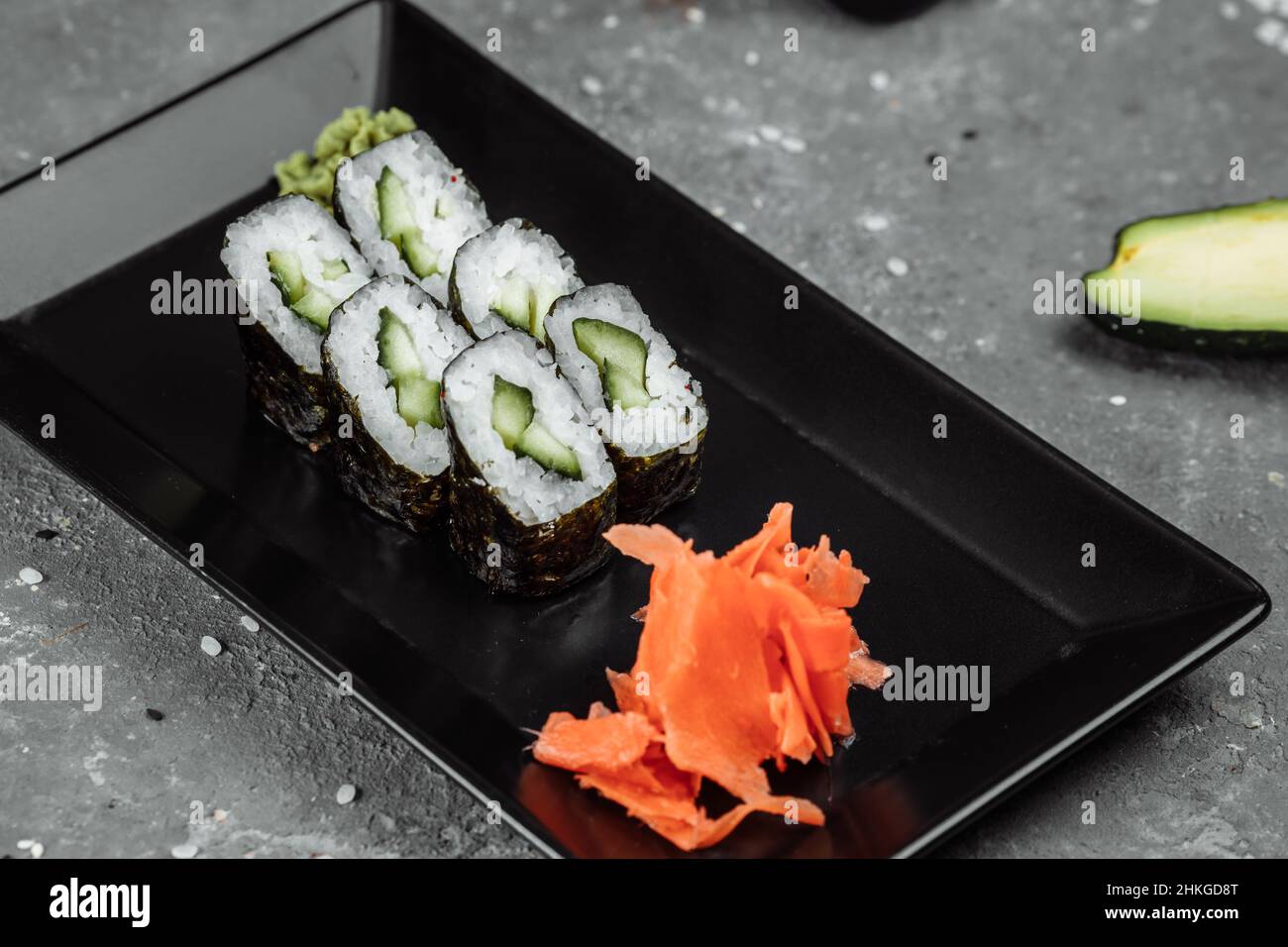 Delicious, juicy and mouth-watering maki with cucumber. Sushi on a gray ...