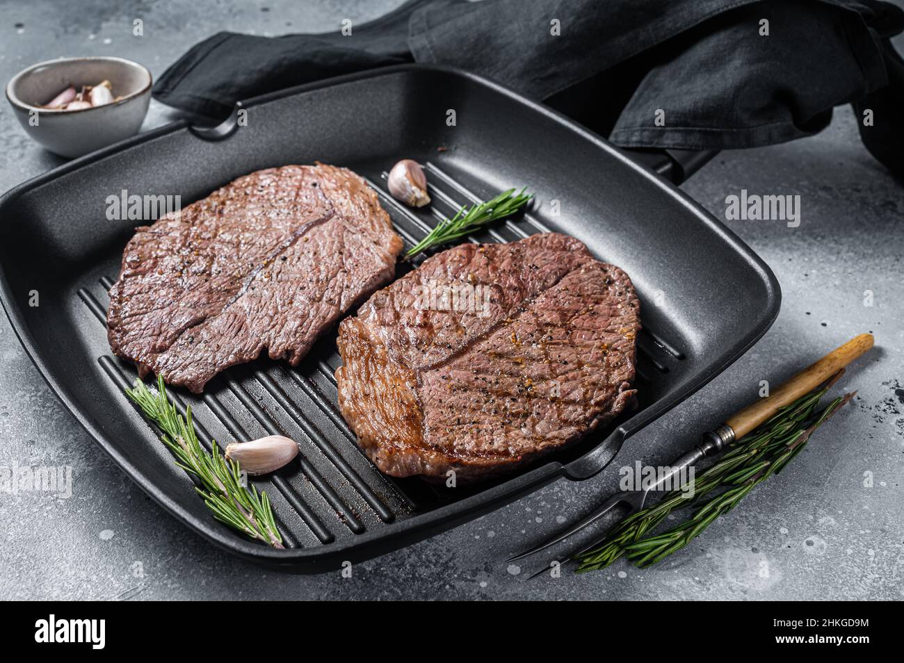 Roasted on grill skillet beef marbled meat steaks. Gray background. Top ...