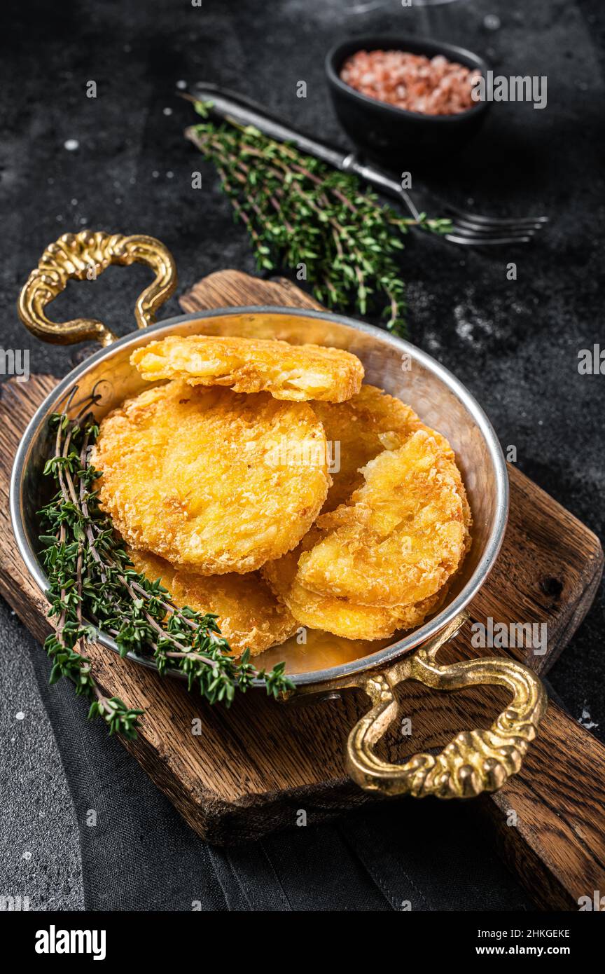 Fried Hash brown potato, hashbrown in a skillet. Black background. Top ...