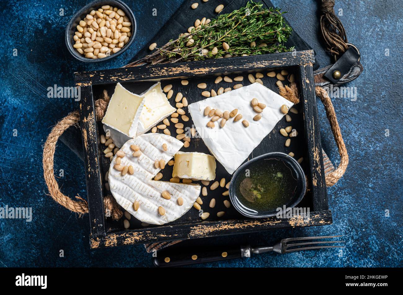 Cheese platter with brie and camembert, wooden tray with nuts. French ...
