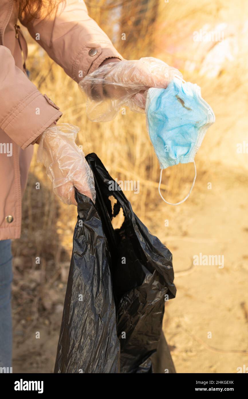 Collecting trash from the local beaches including used face masks Stock ...