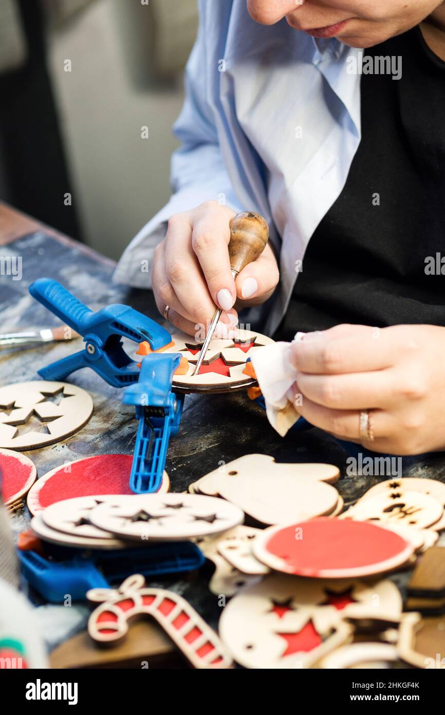 Closeup process making handmade wooden Christmas toys in carpentry ...