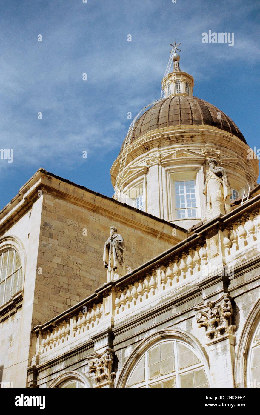 Stone statues on the balustrade of an ancient temple against the ...