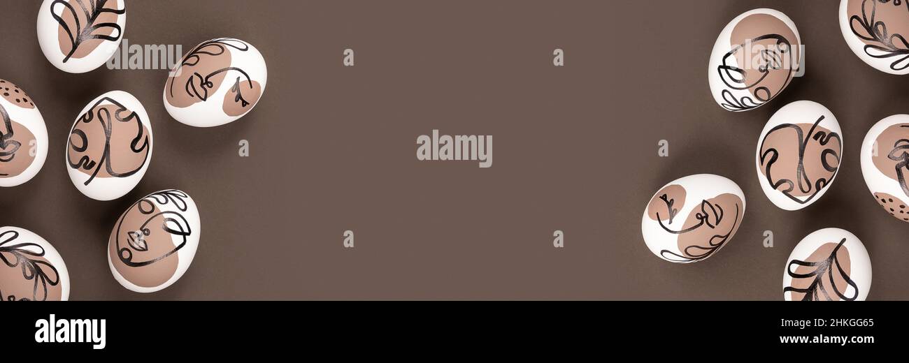 Happy Easter concept. Surreal faces on eggs on brown background. Art ...