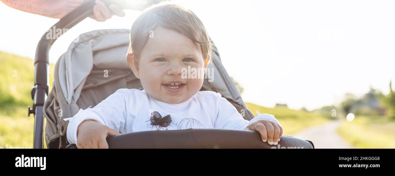 Horizontal banner or header with happy laughing baby girl enjoying a ...
