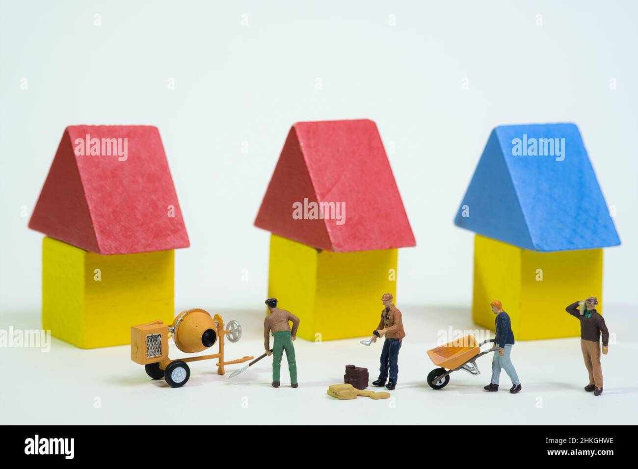 a team of workers with cement mixers and wheelbarrows are working Stock ...