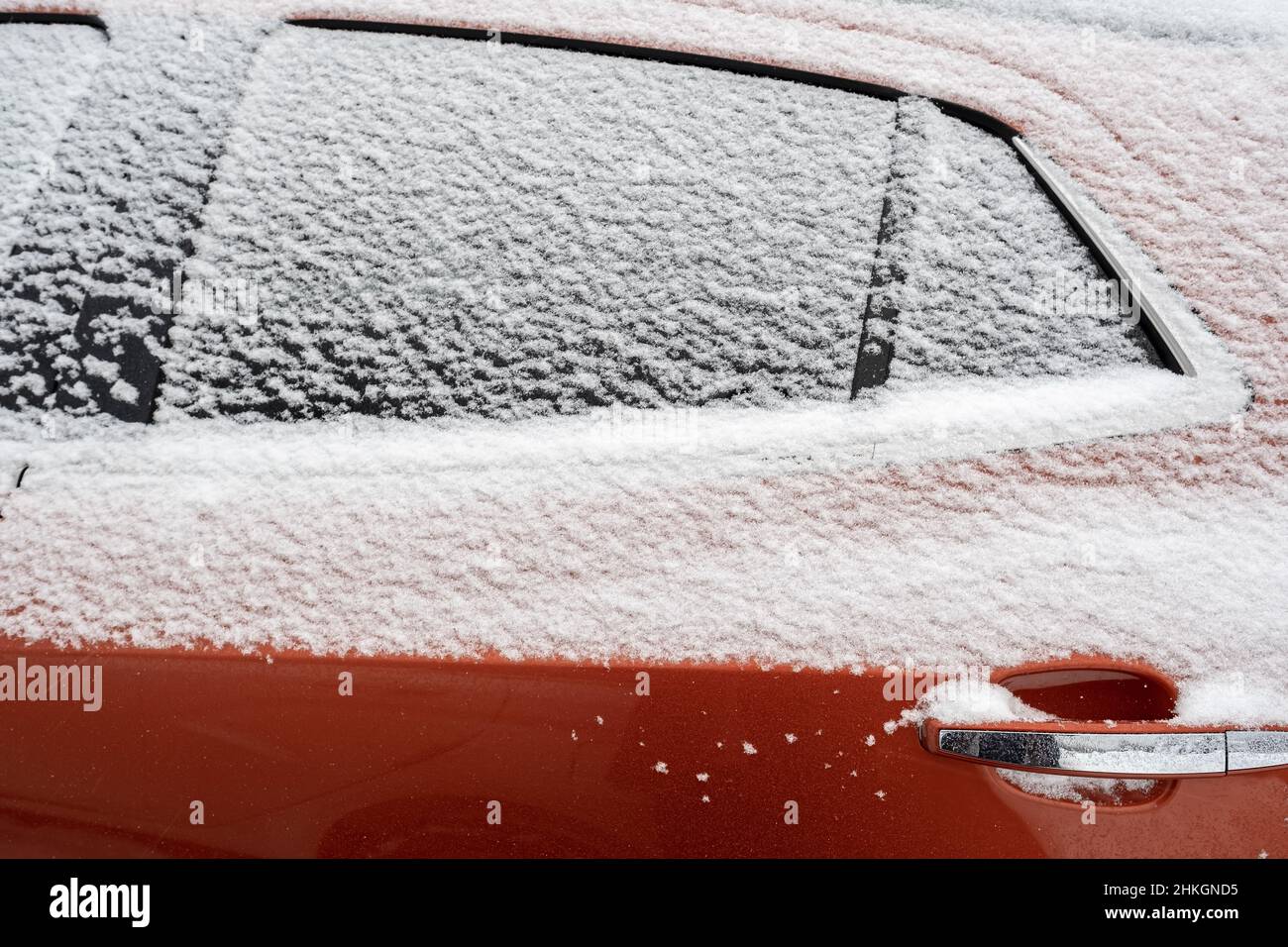 Snow-covered doors and windows of a car, outdoors, on a winter day ...