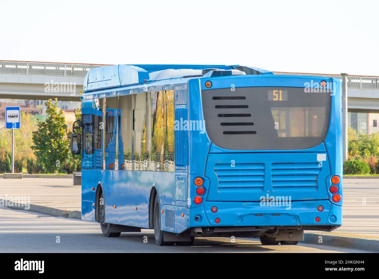 City bus in blue at the bus stop before departure, rear view Stock ...