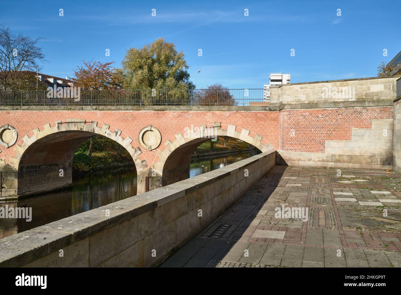 River bank with an old brick bridge and bank reinforcement Stock Photo ...