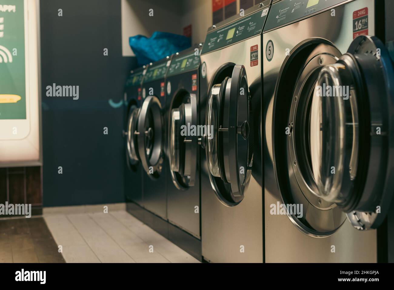 Laundromat inside in the evening, washing machines in a laundromat ...