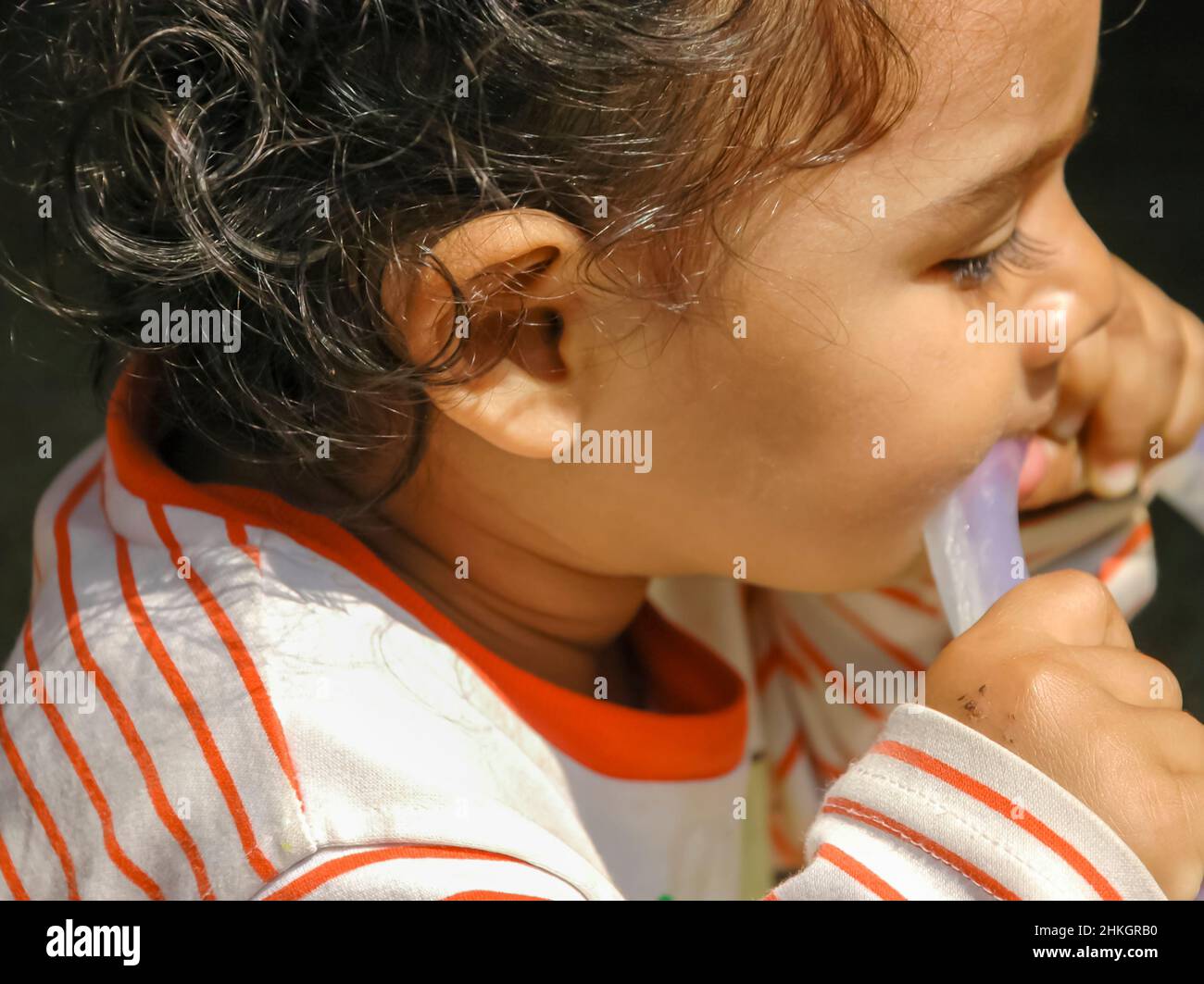 A portrait of an East Indian baby boy / child / kid showing signs of ...