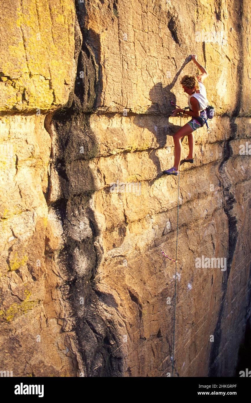 Female rock climber climbing a difficult route at Windy Point. Santa ...