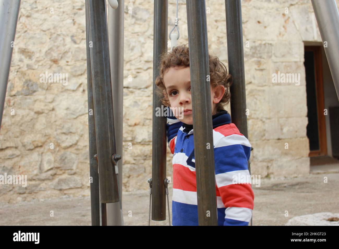 my son likes to play between the bars Stock Photo - Alamy