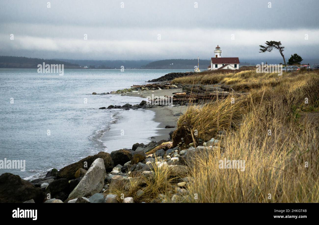 Cold seas and a dramatic sky backdrop the Point Wilson Lighthouse in ...