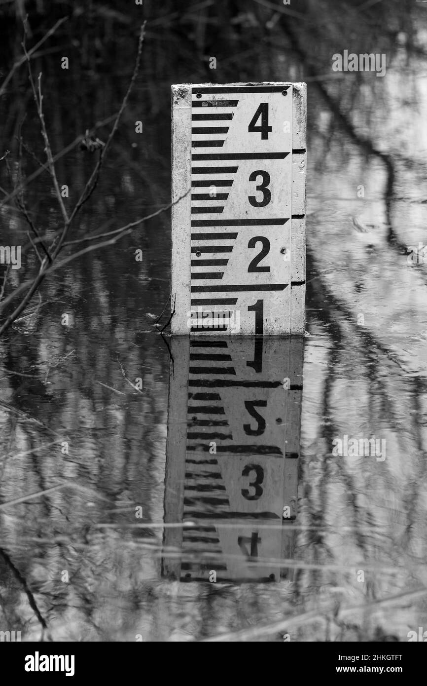 Water depth gauge in small river white with black readings part ...