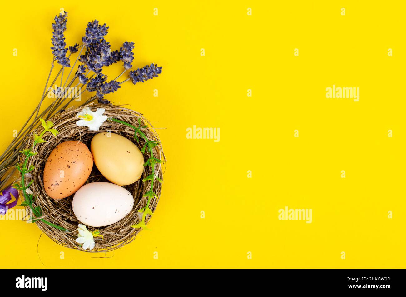 Top view of color easter haqndmade eggs and nest flatlay. Trendy ...