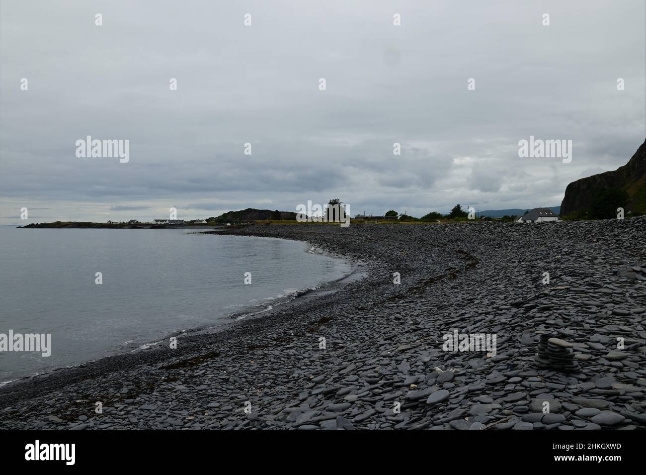 A view along the slate covered beach at Ellenabeich on the Isle of Seil ...