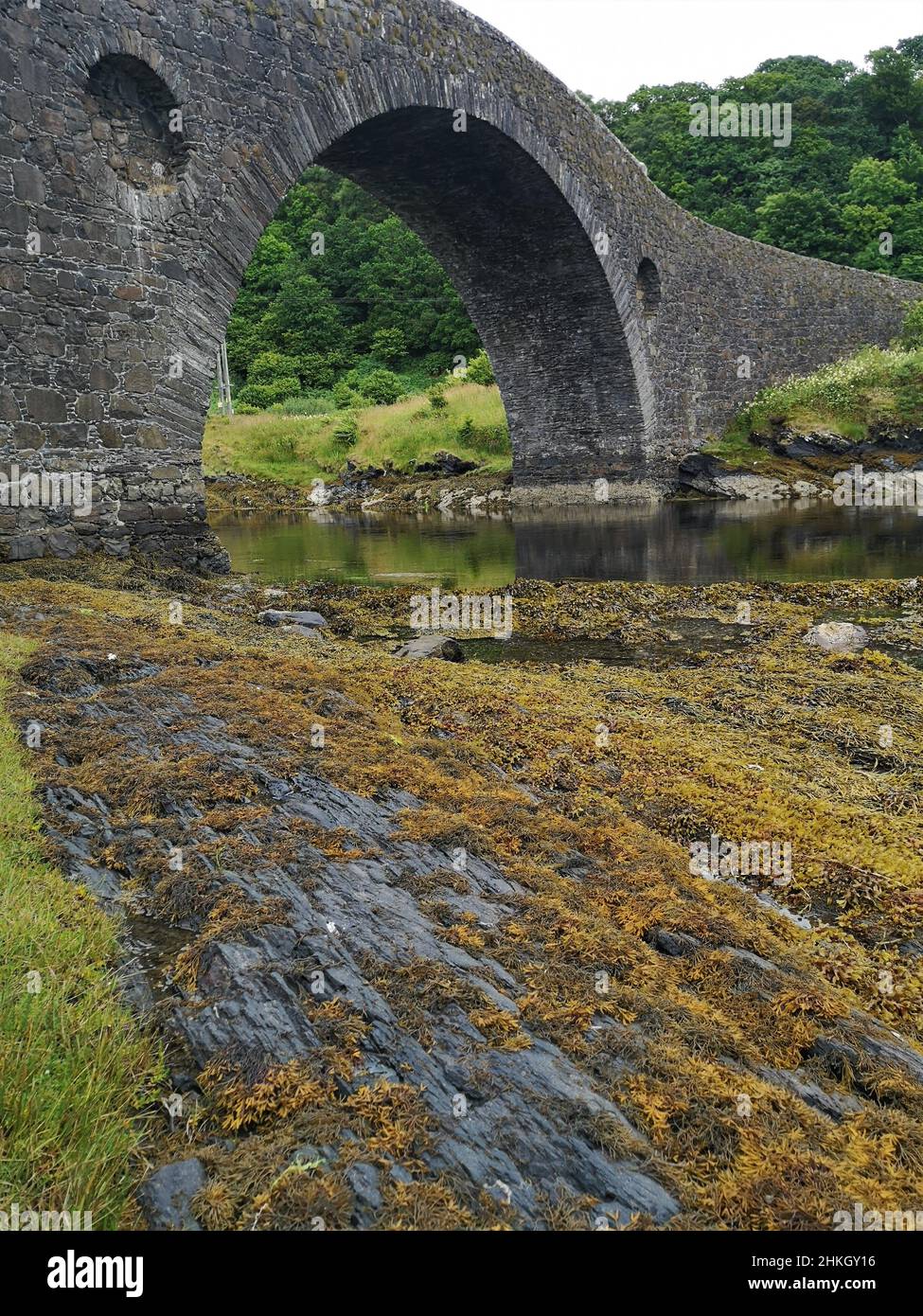 A view of the old stone bridge over the Atlantic. A narrow stretch of ...