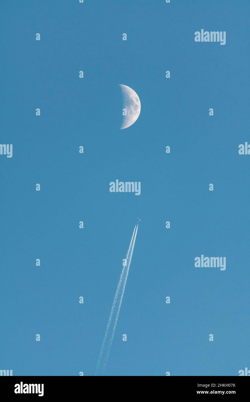 Plane passing near the moon Stock Photo - Alamy