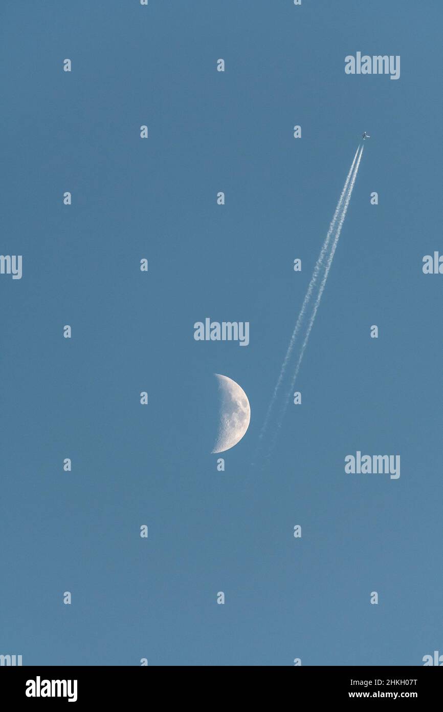 Plane passing near the moon Stock Photo - Alamy