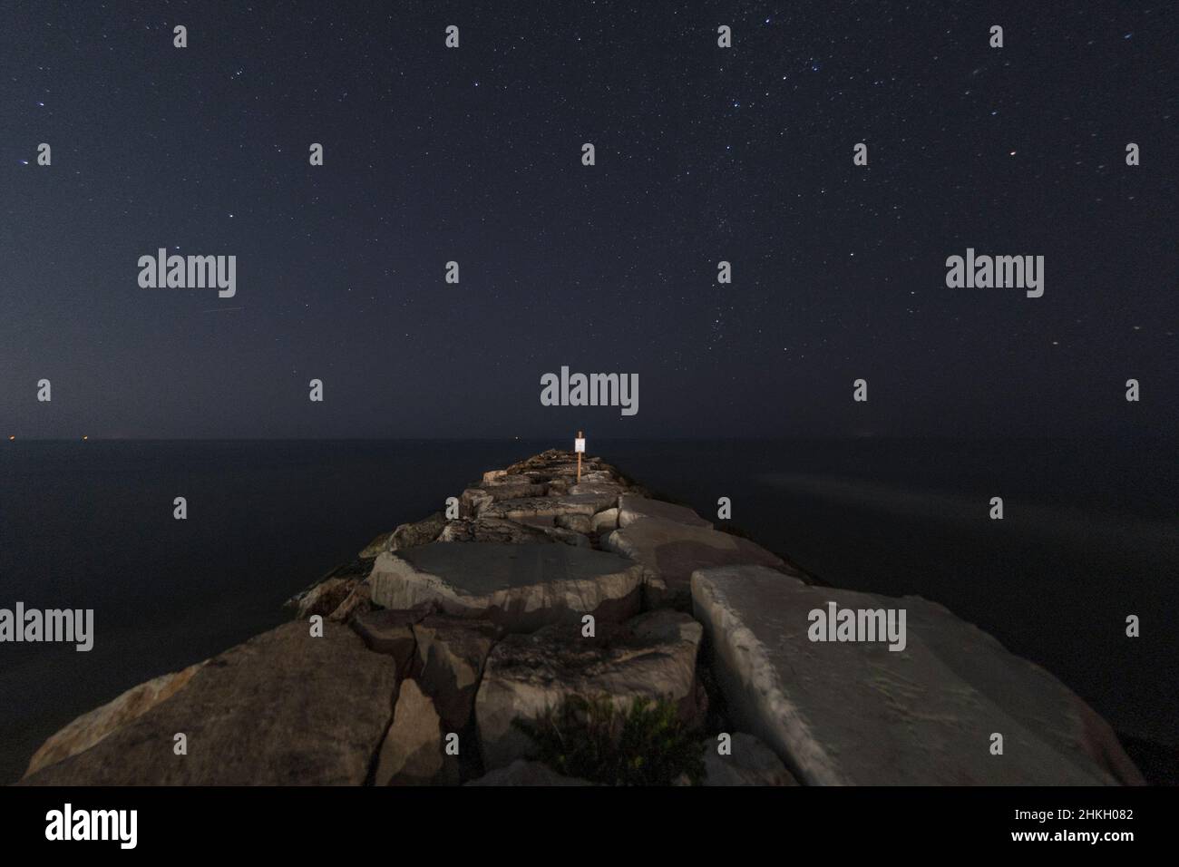 Sea with starry night sky seen from the cliff Stock Photo - Alamy