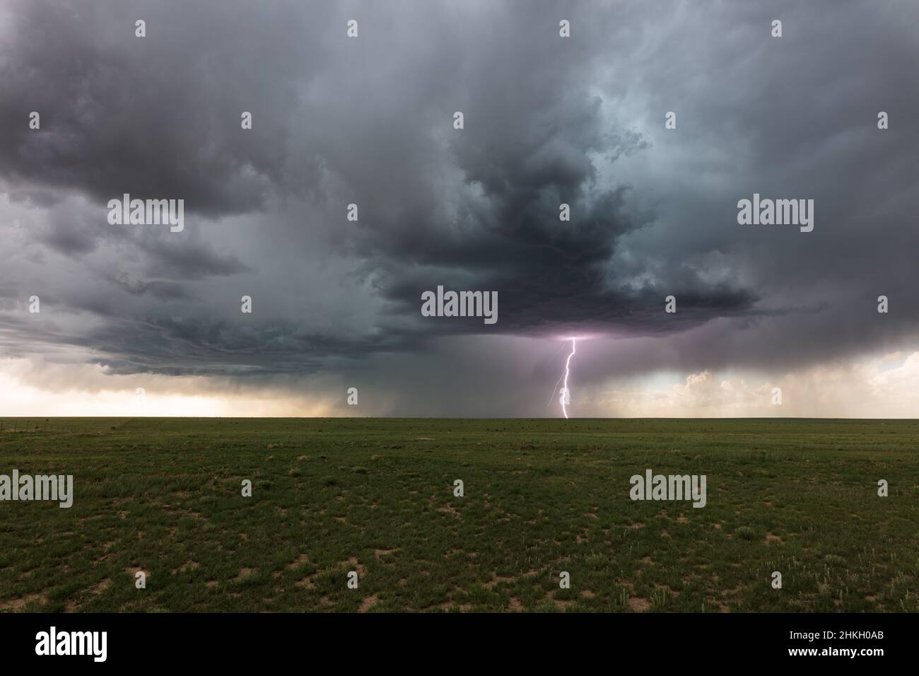Scenic landscape with dark clouds and a lightning strike from a summer ...