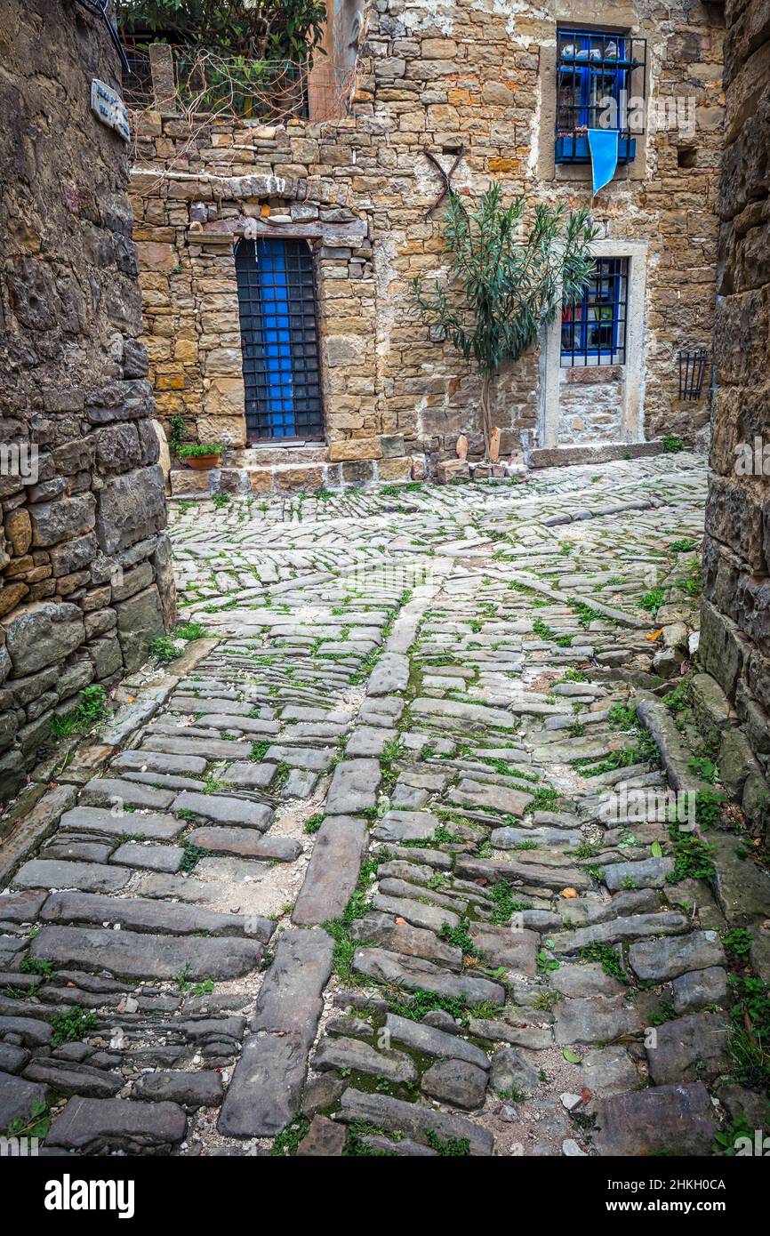 Stone facades of old houses in ancient streets. The Groznjan village on ...
