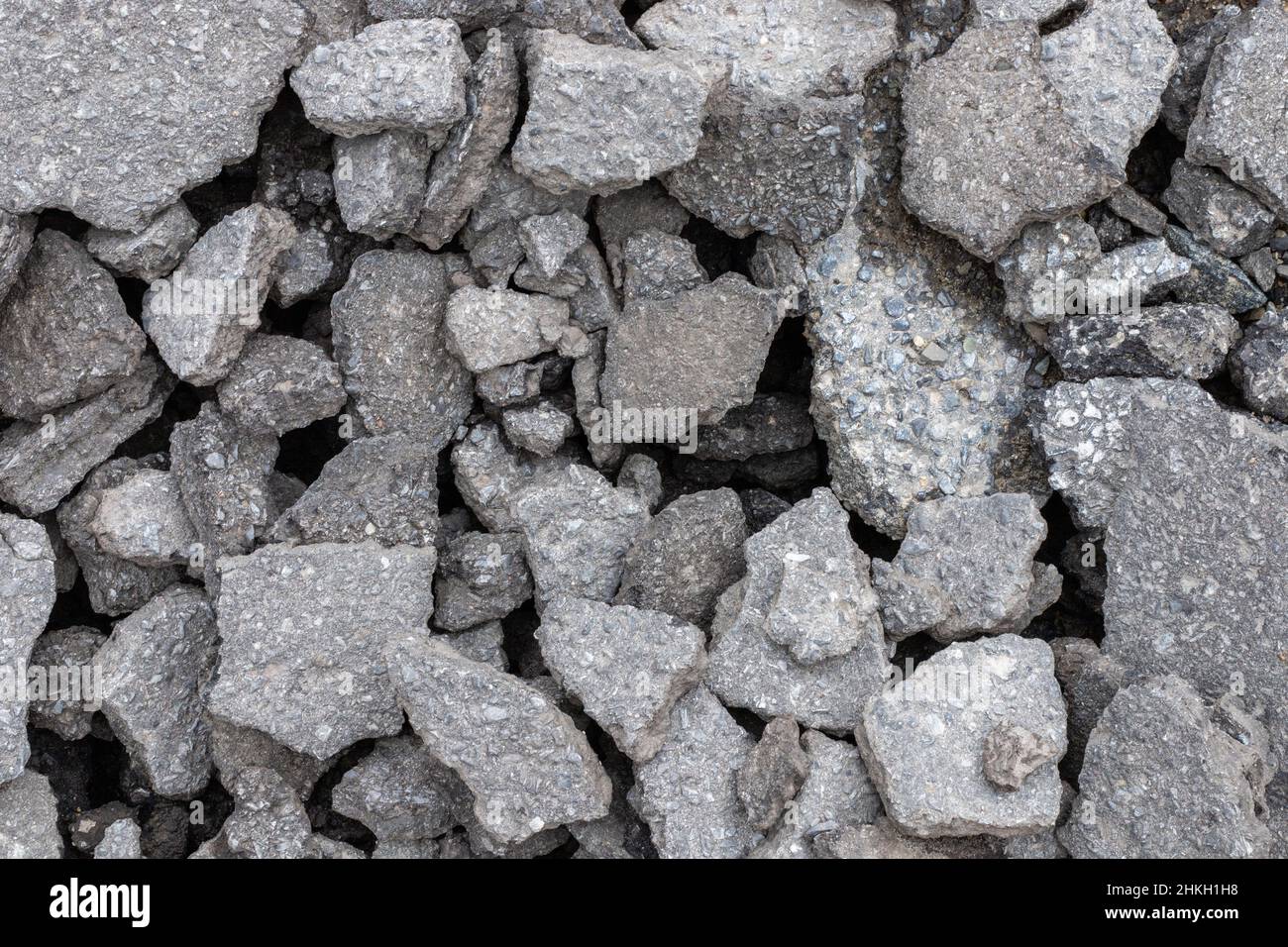 Pile of old cracked asphalt rubble close up, abstract industrial ...