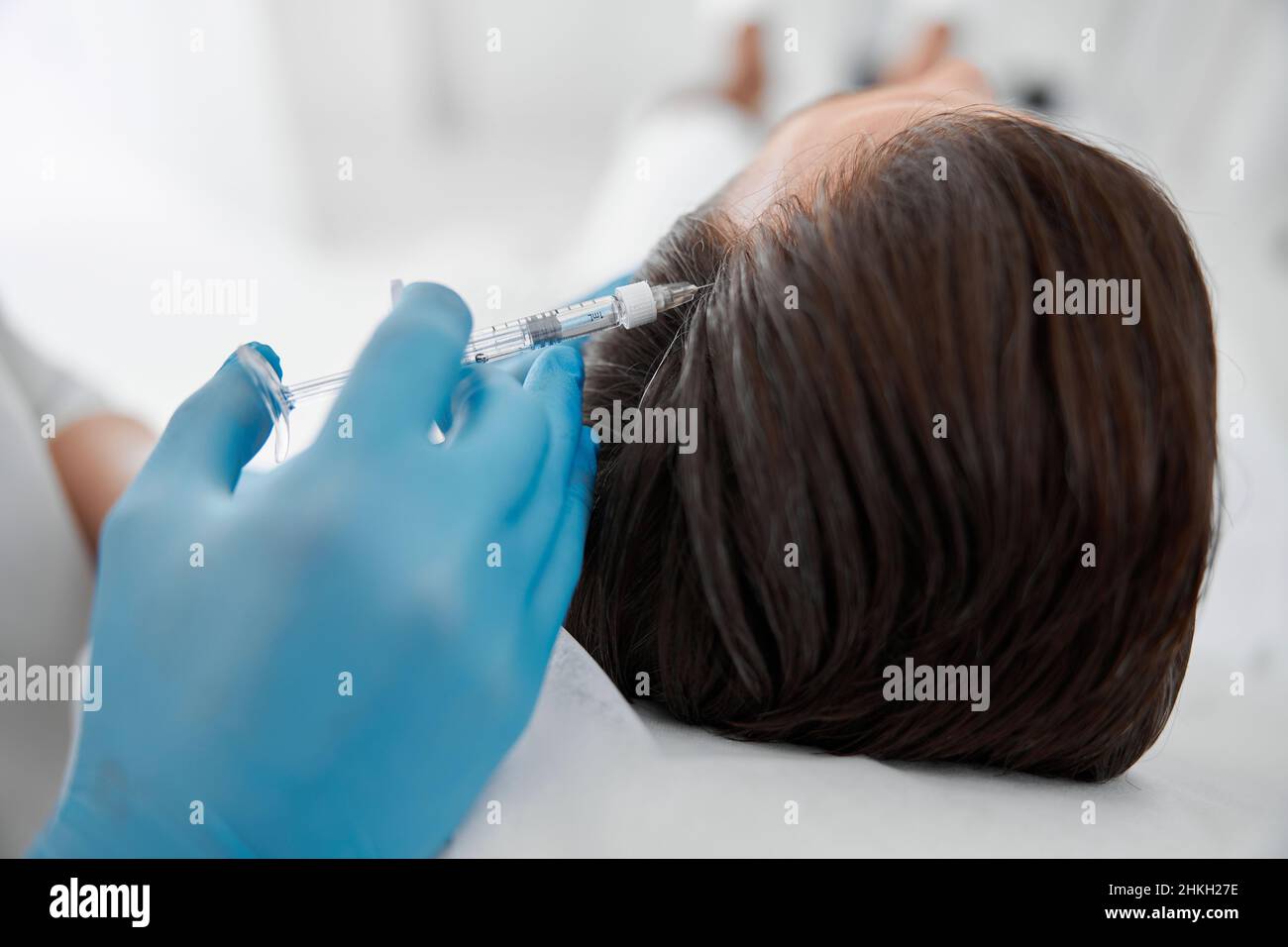 Specialist does injection in patient head skin during meso therapy ...