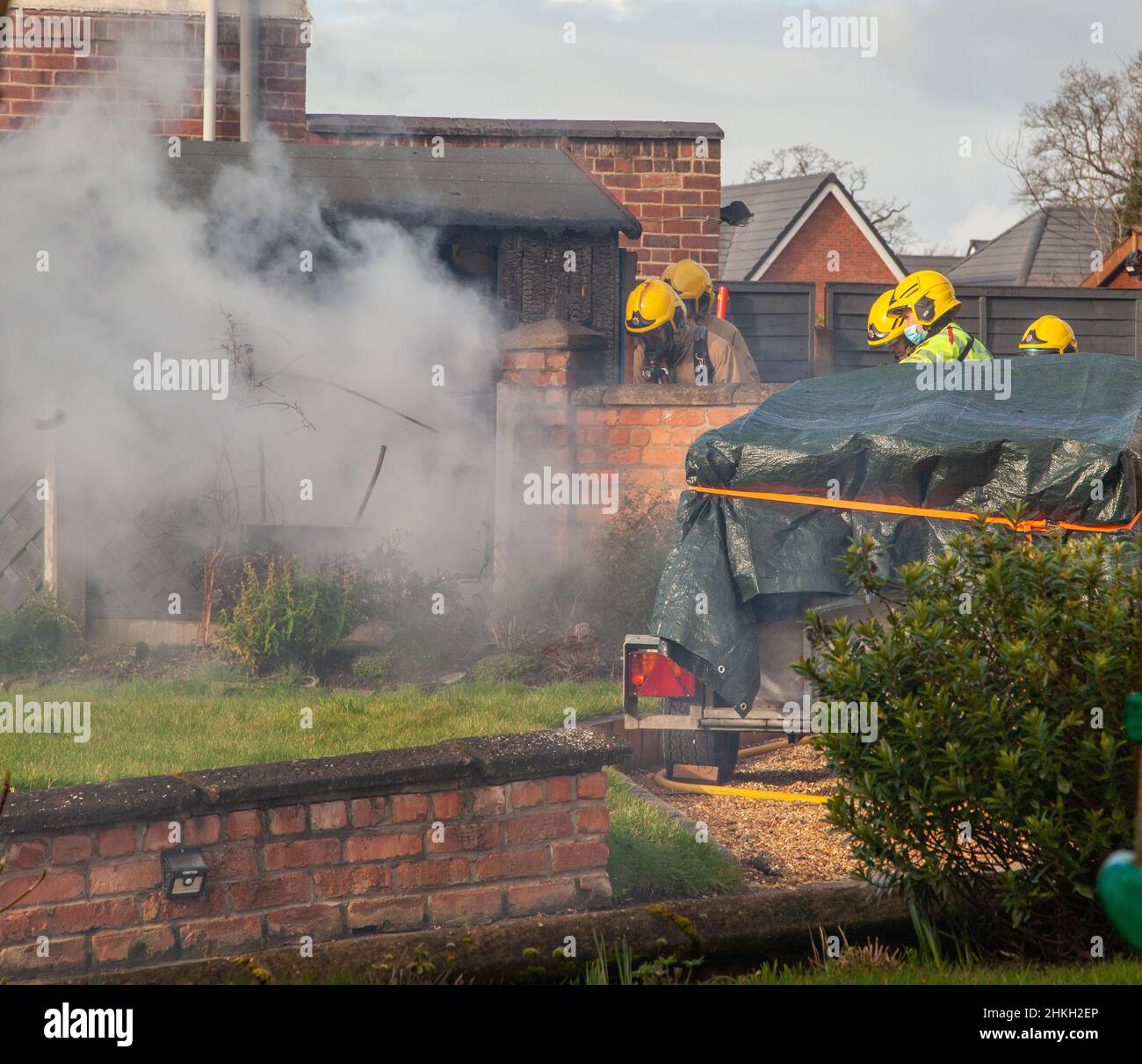 Firemen from the Cheshire fire and recue service attending a garden ...