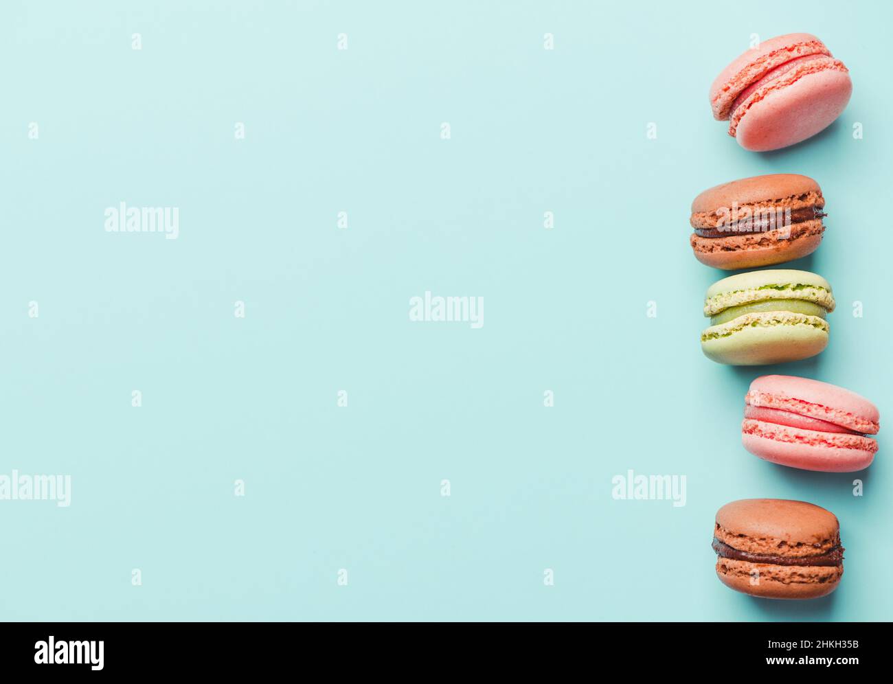 turquoise background with five macarons on the right side Stock Photo ...