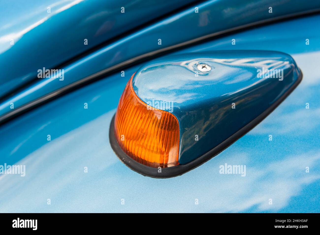 Side elevation close-up view of the left turn signal of a metallic blue ...