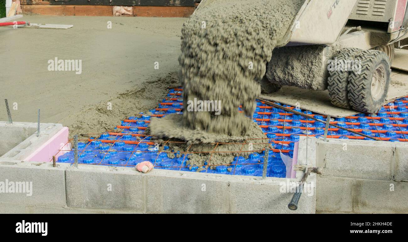 Concrete being poured over hydronic sub floor Stock Photo - Alamy