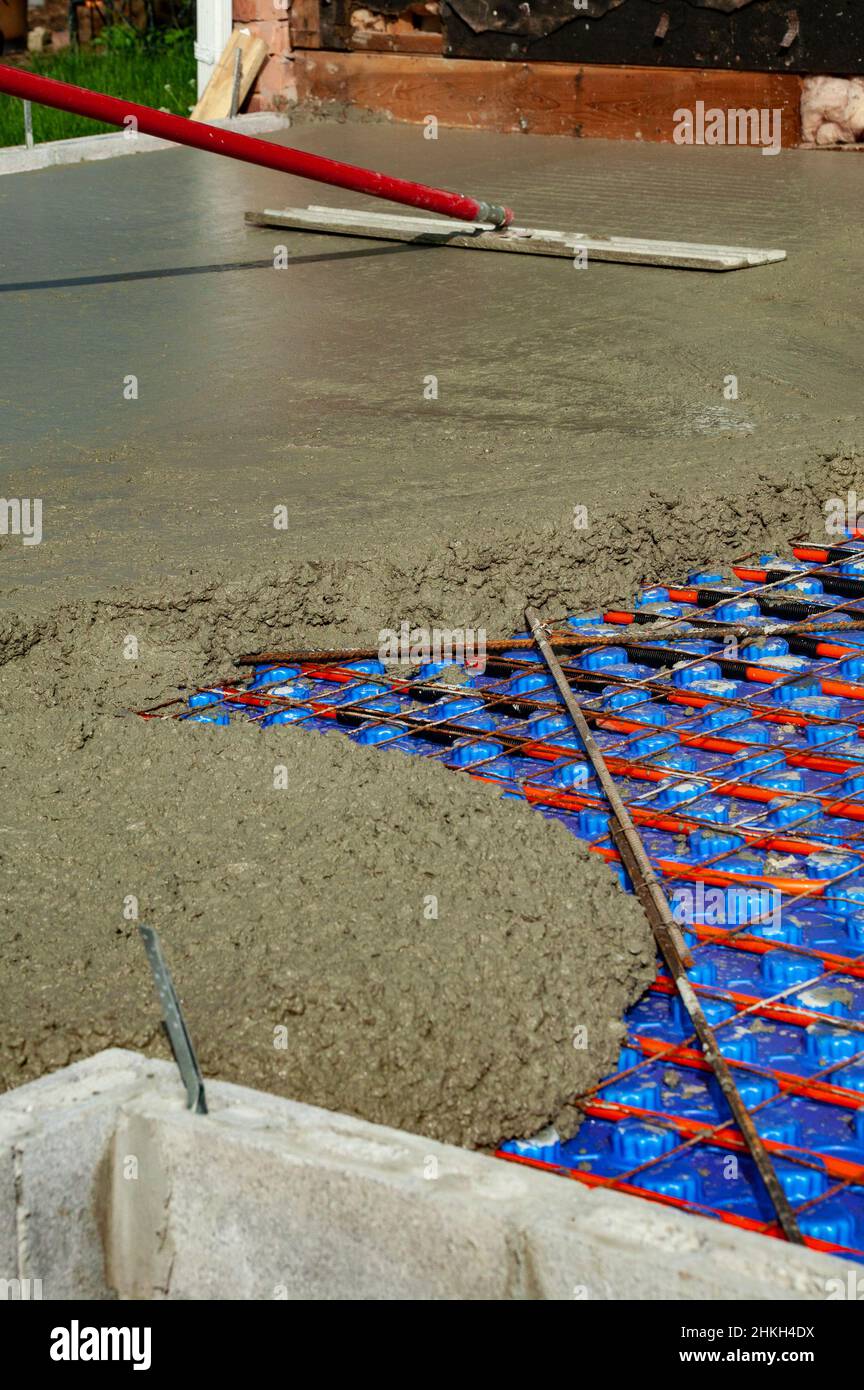 Concrete smoothed over hydronics sub flooring Stock Photo - Alamy
