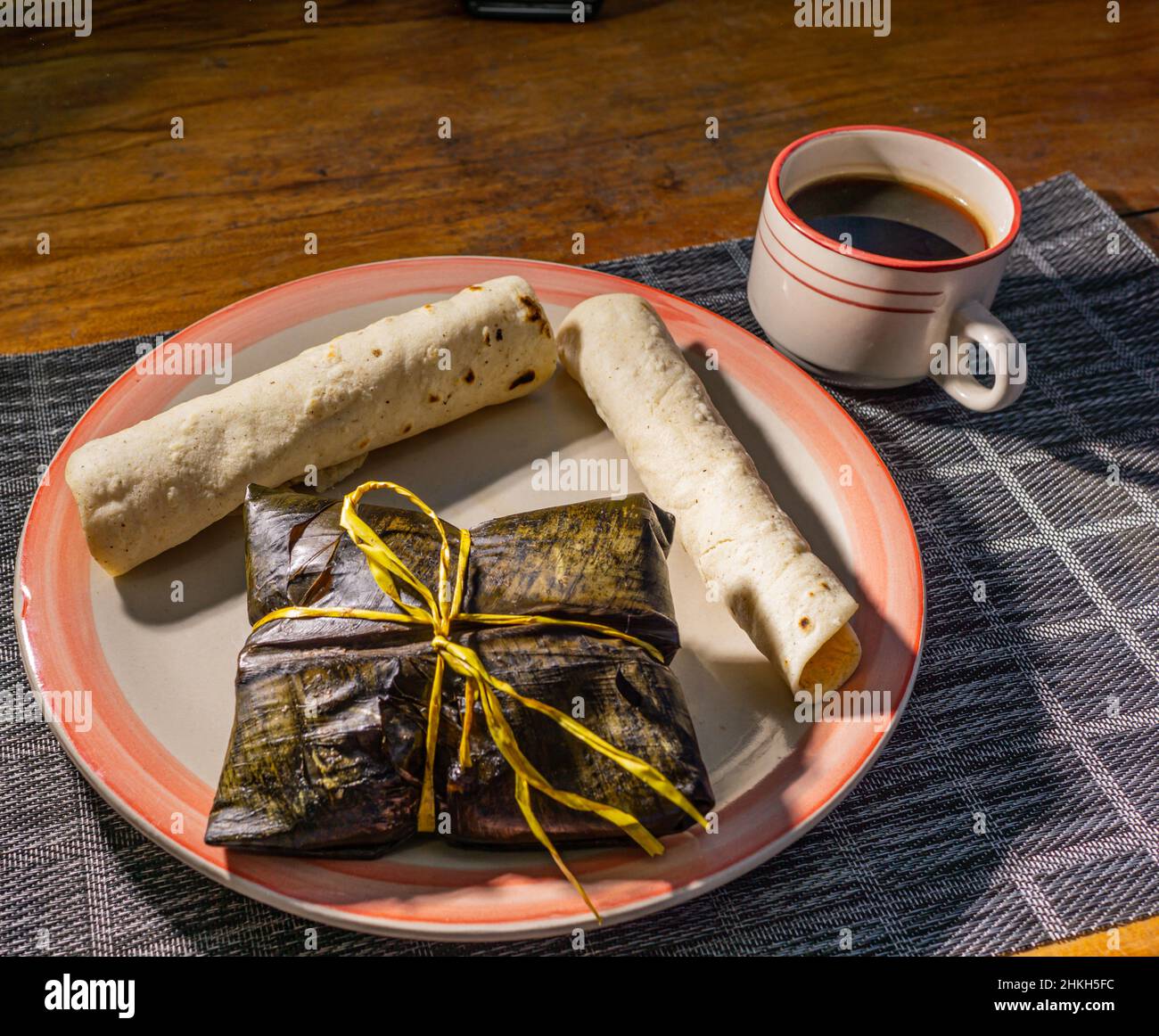 Nacatamal wrapped in banana leaf. It is made from masa, potatoes, meat ...
