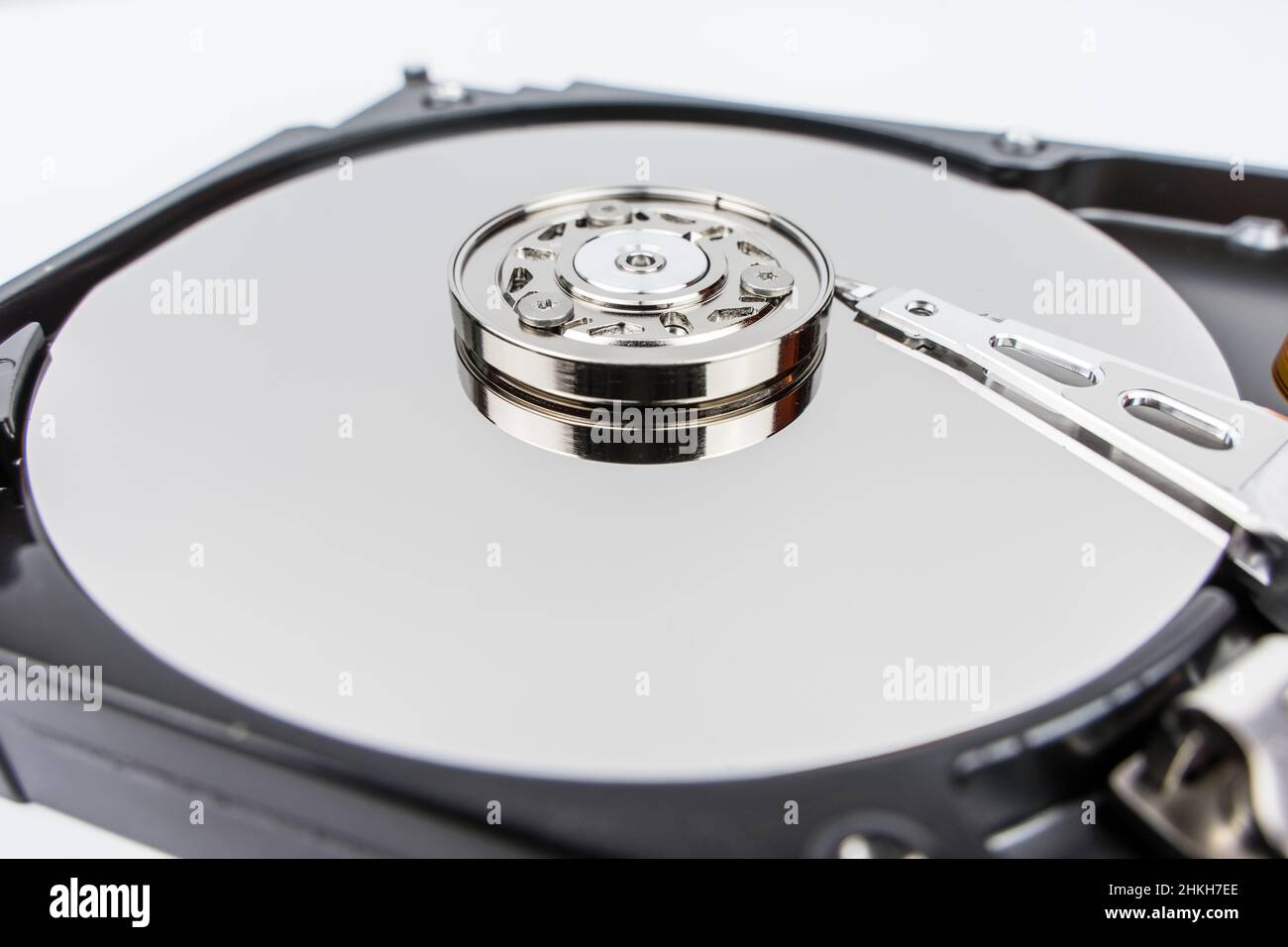 Close-up photo of the inside of a hard drive on a white background ...
