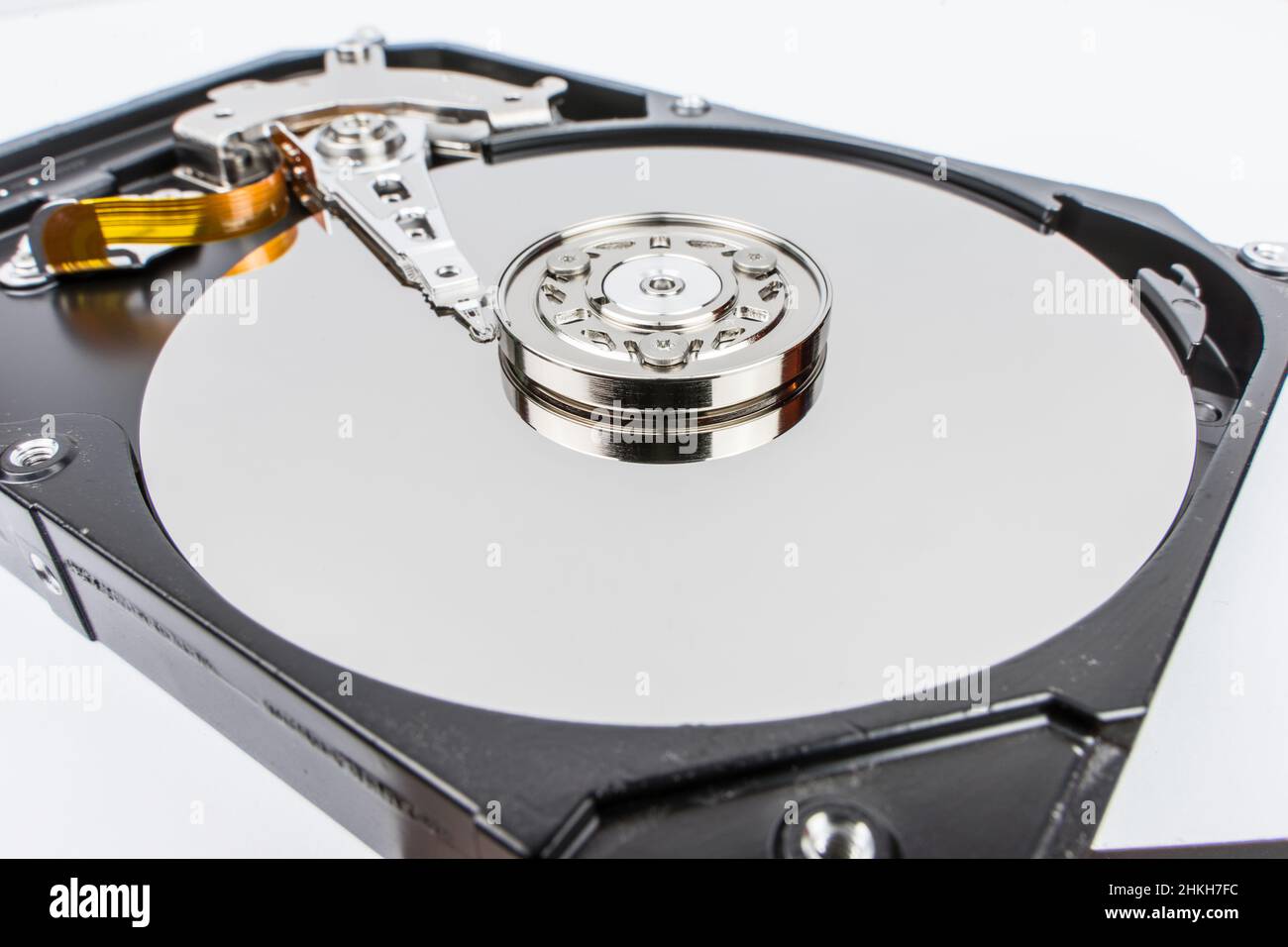 Close-up photo of the inside of a hard drive on a white background ...