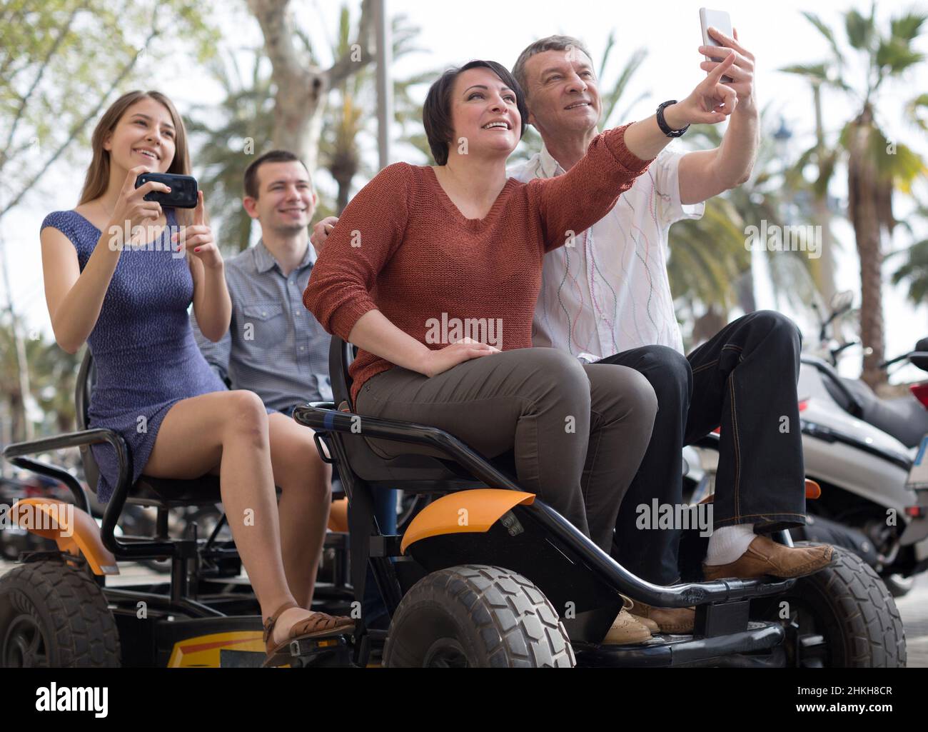 family of tourists enjoy a walk on the bike carriage Stock Photo - Alamy
