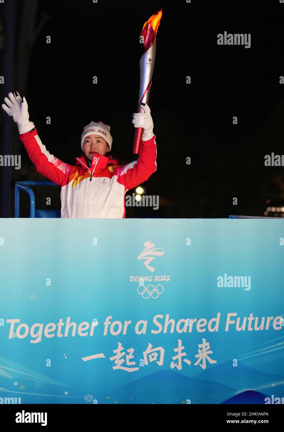 Beijing, China. 4th Feb, 2022. Torch bearer Zhang Junying prepares to ...