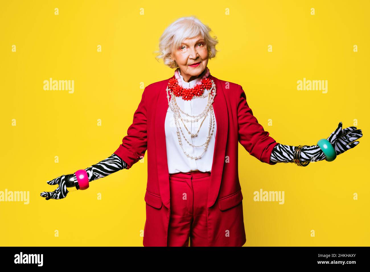 Happy and funny cool old lady with fashionable clothes portrait on ...