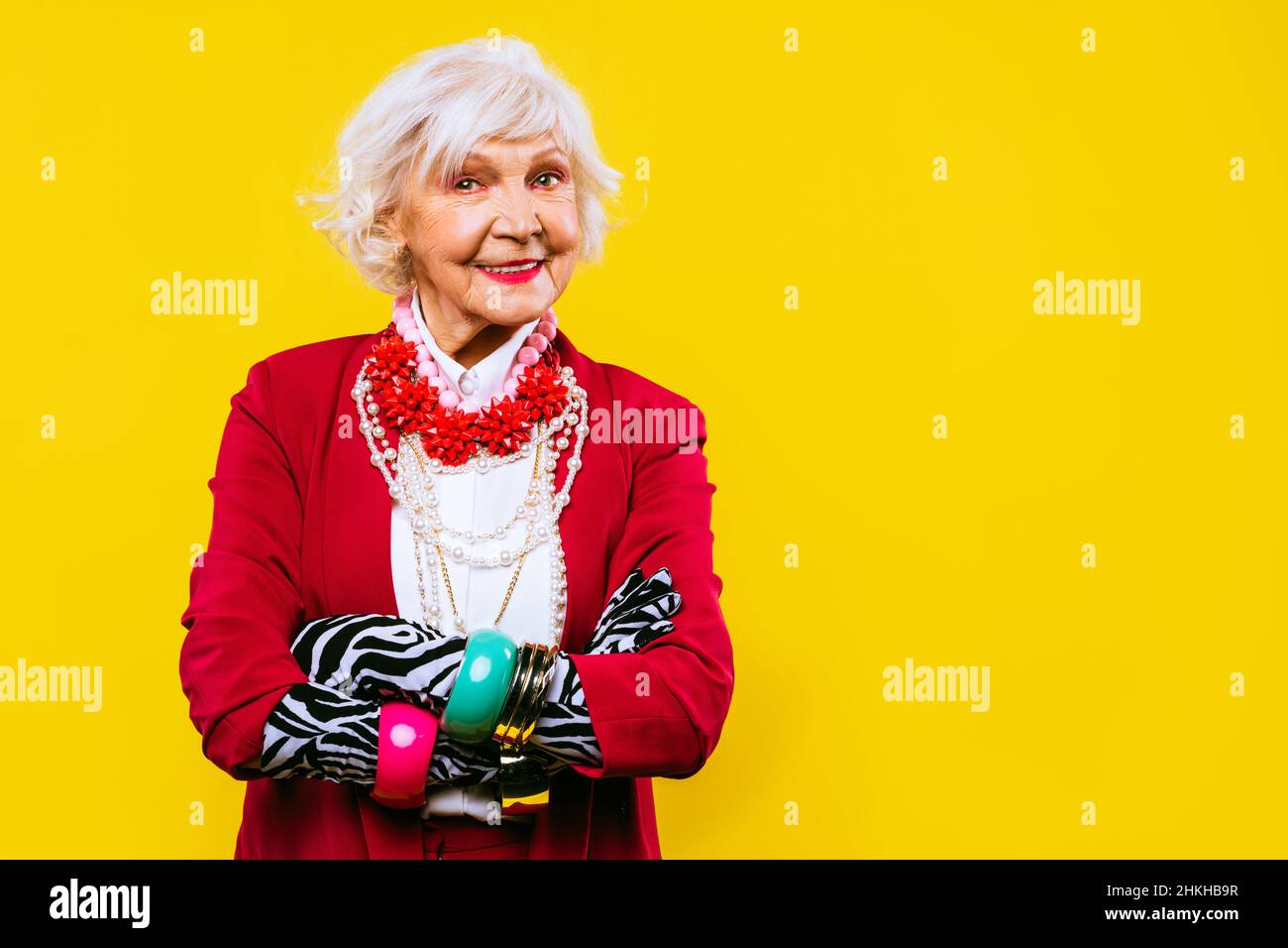 Happy and funny cool old lady with fashionable clothes portrait on ...