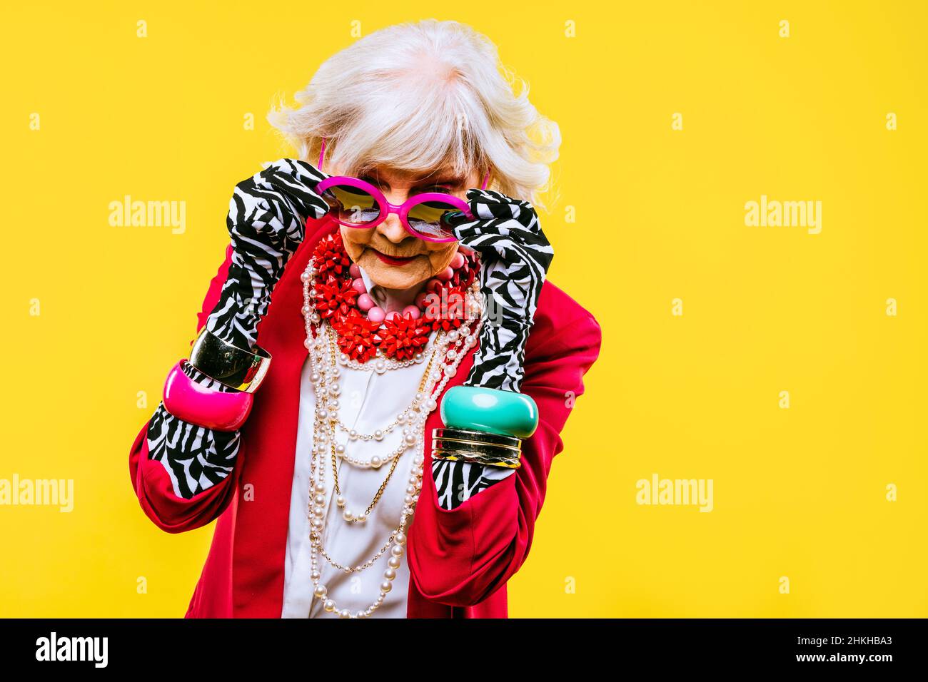 Happy and funny cool old lady with fashionable clothes portrait on ...