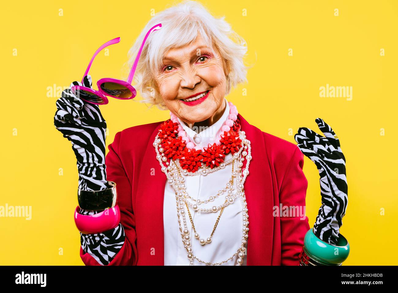 Happy and funny cool old lady with fashionable clothes portrait on ...