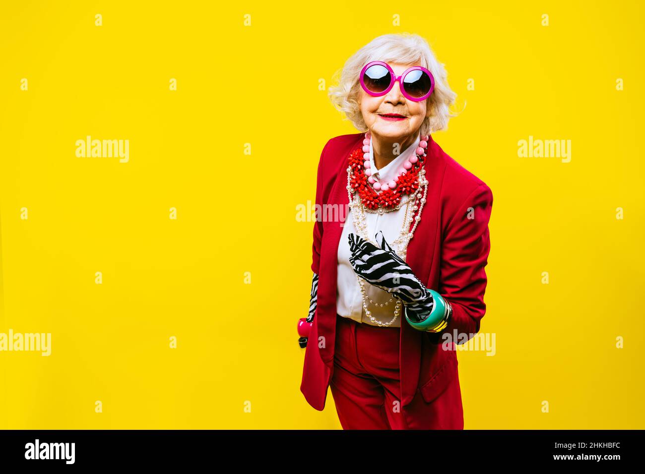 Happy and funny cool old lady with fashionable clothes portrait on ...