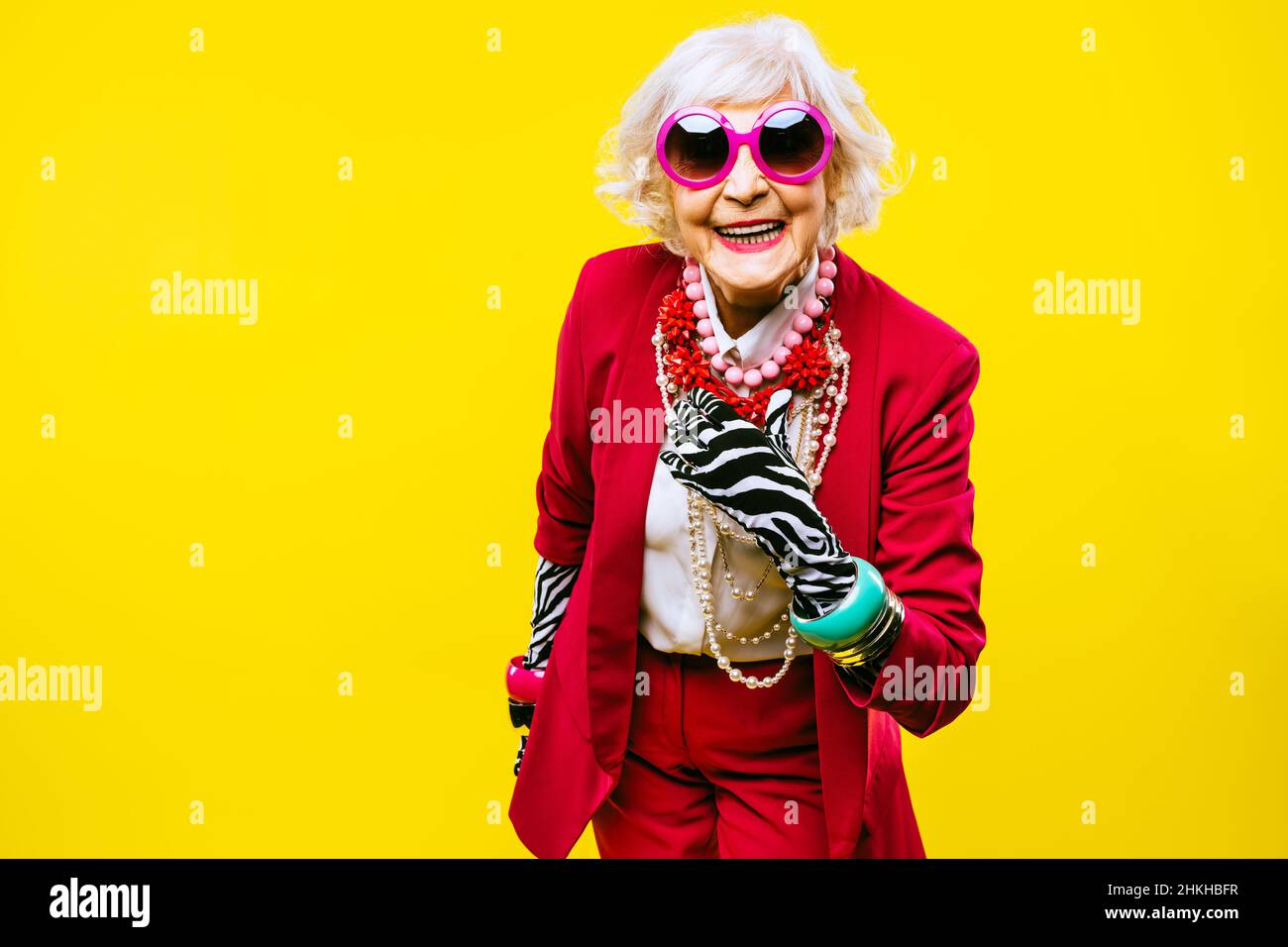 Happy and funny cool old lady with fashionable clothes portrait on ...